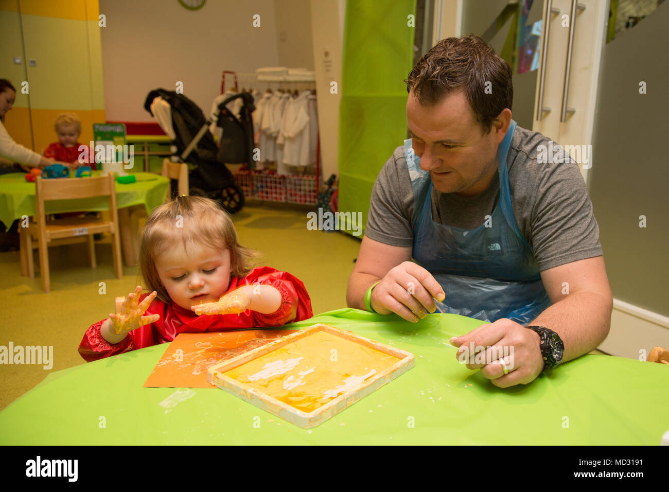 Father and daughter at messy play Stock Photo - Alamy