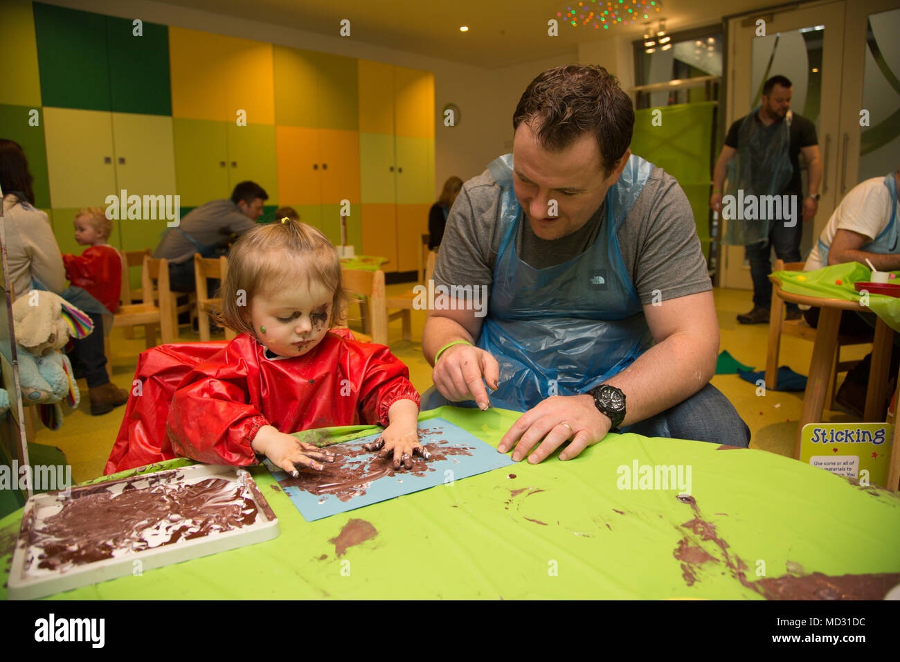 Father and daughter at messy play Stock Photo - Alamy