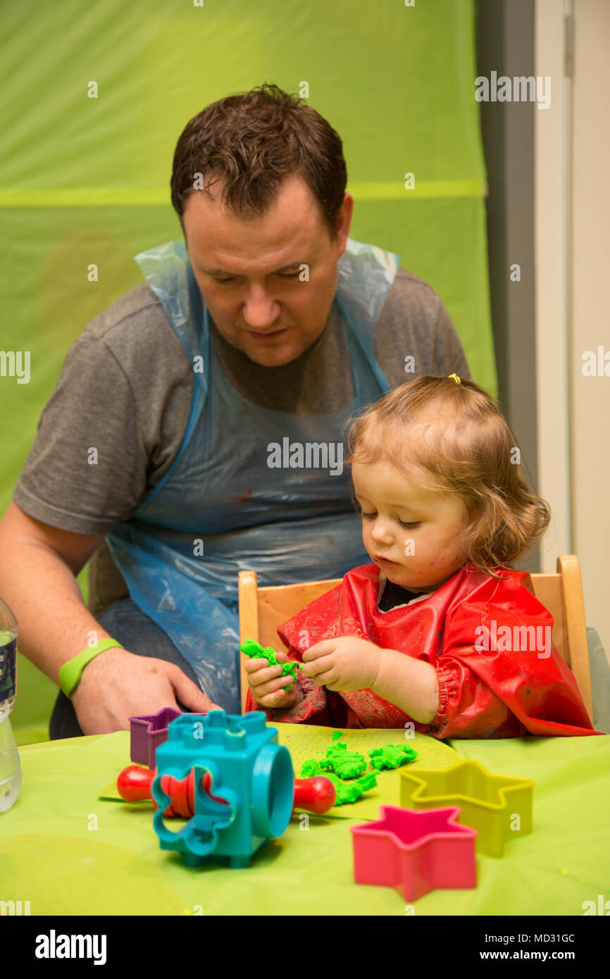 Father and daughter at messy play Stock Photo - Alamy