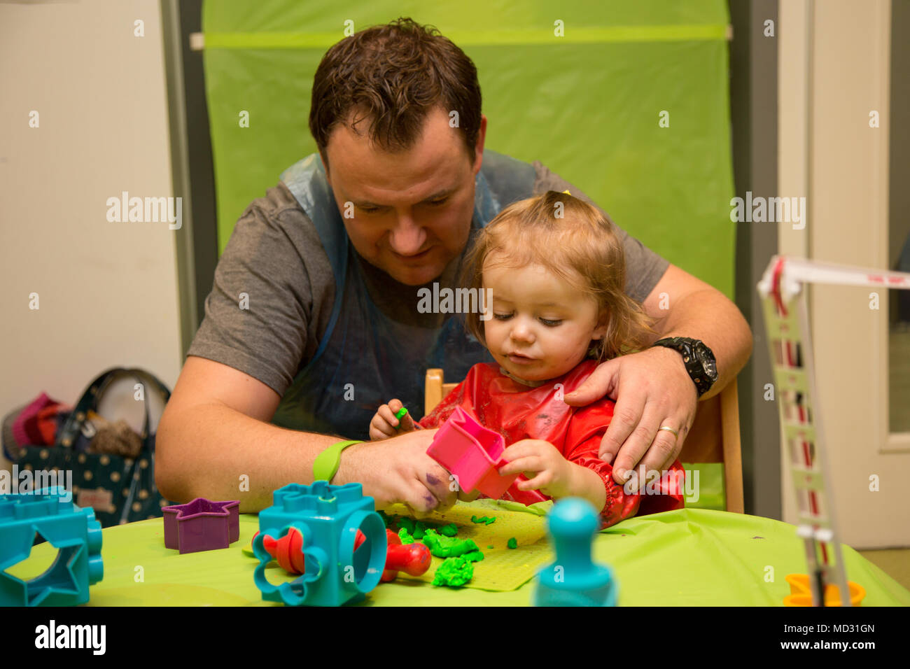 Father and daughter at messy play Stock Photo - Alamy