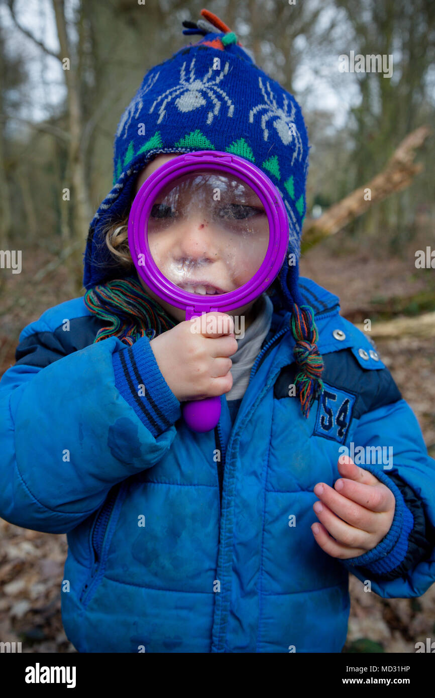 A toddler with a large magnifying glass outdoors, UK Stock Photo - Alamy