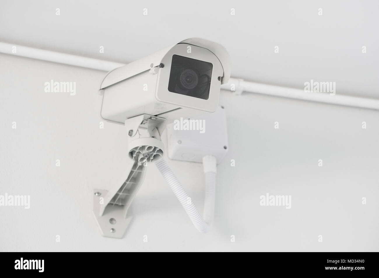 CCTV security camera installed on the building wall, operating indoor ...