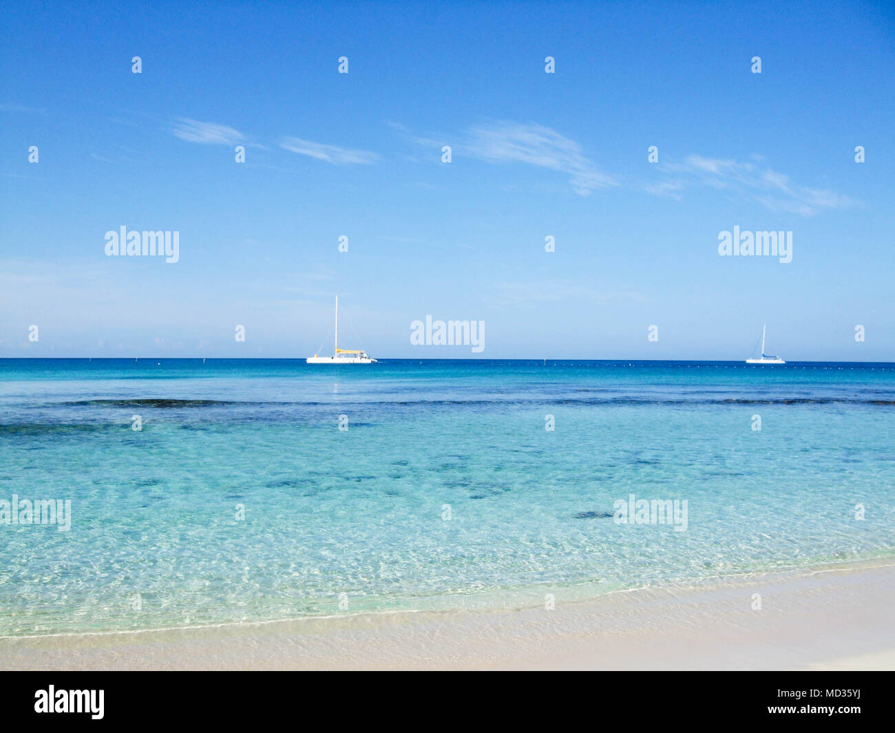 Beautiful oceanview with boats and blue sky Stock Photo - Alamy