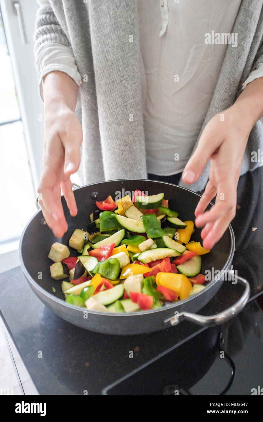 Cooking at home-Person mixing selection of fresh Rawvegetables in a ...