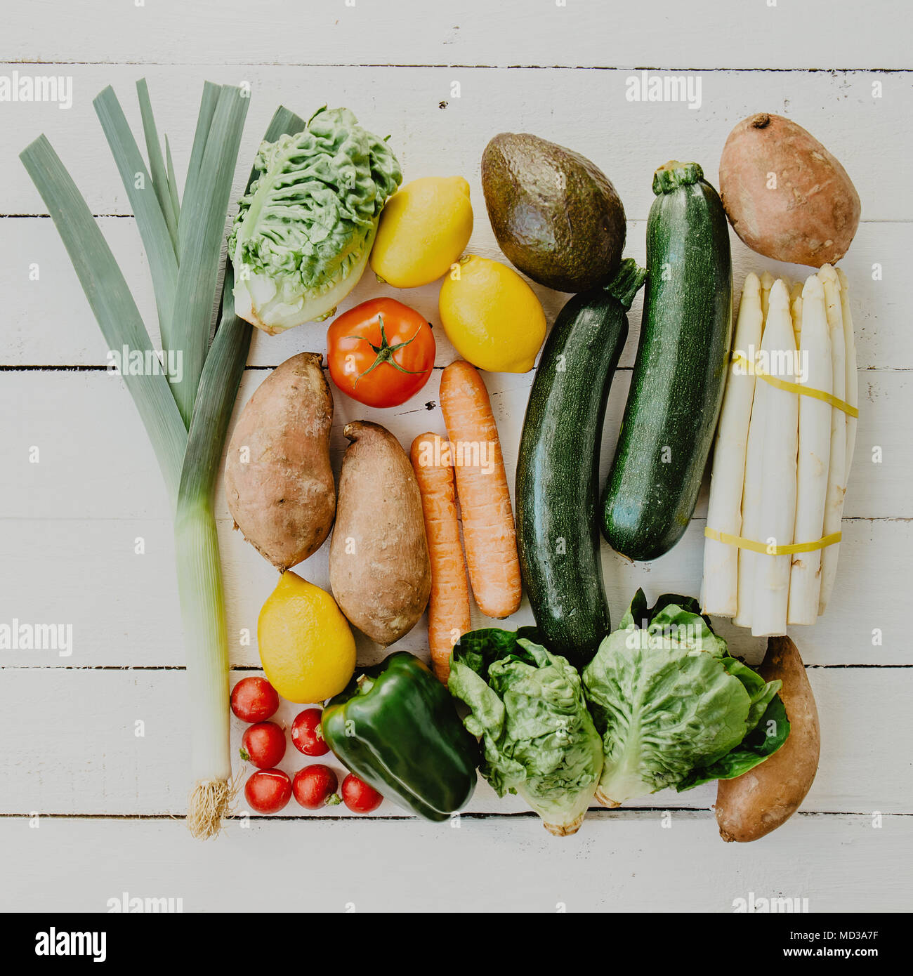Flat lay of arranged fresh vegetables lying in order on white wood ...