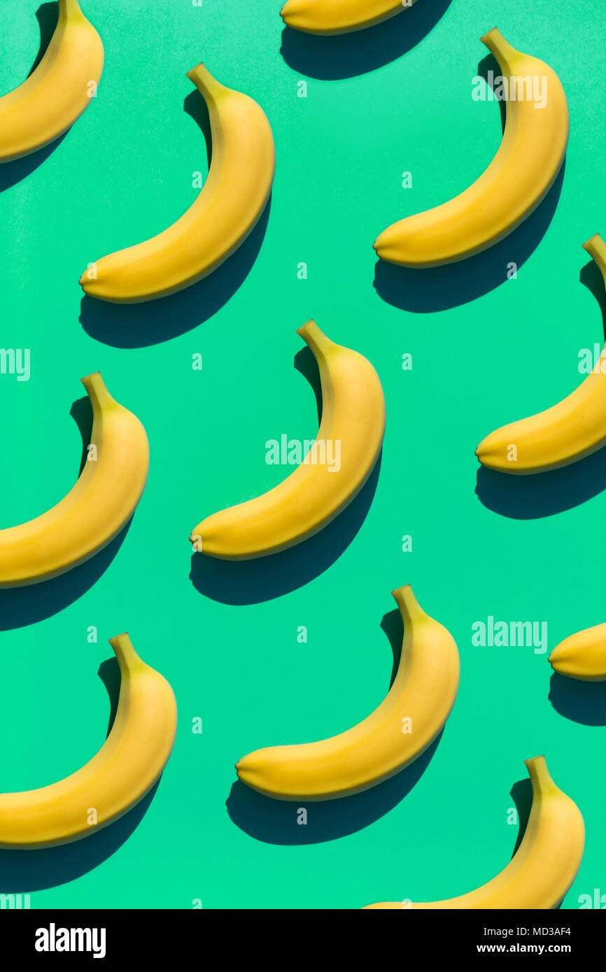 Flat lay of arranged yellow bright bananas in seamless pattern on light ...
