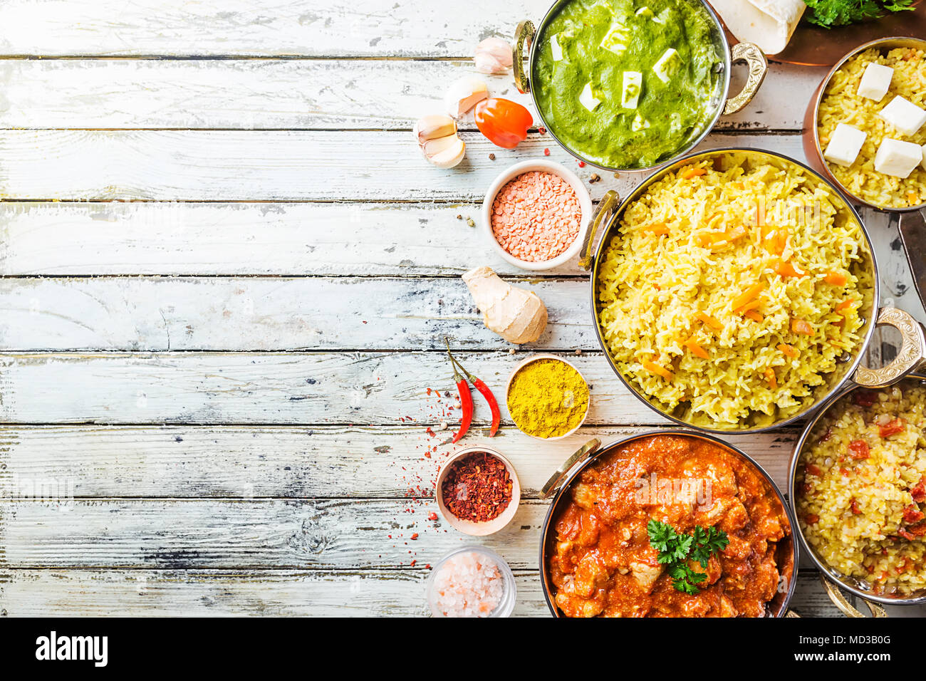 Different bowls with assorted indian food on white wooden background ...