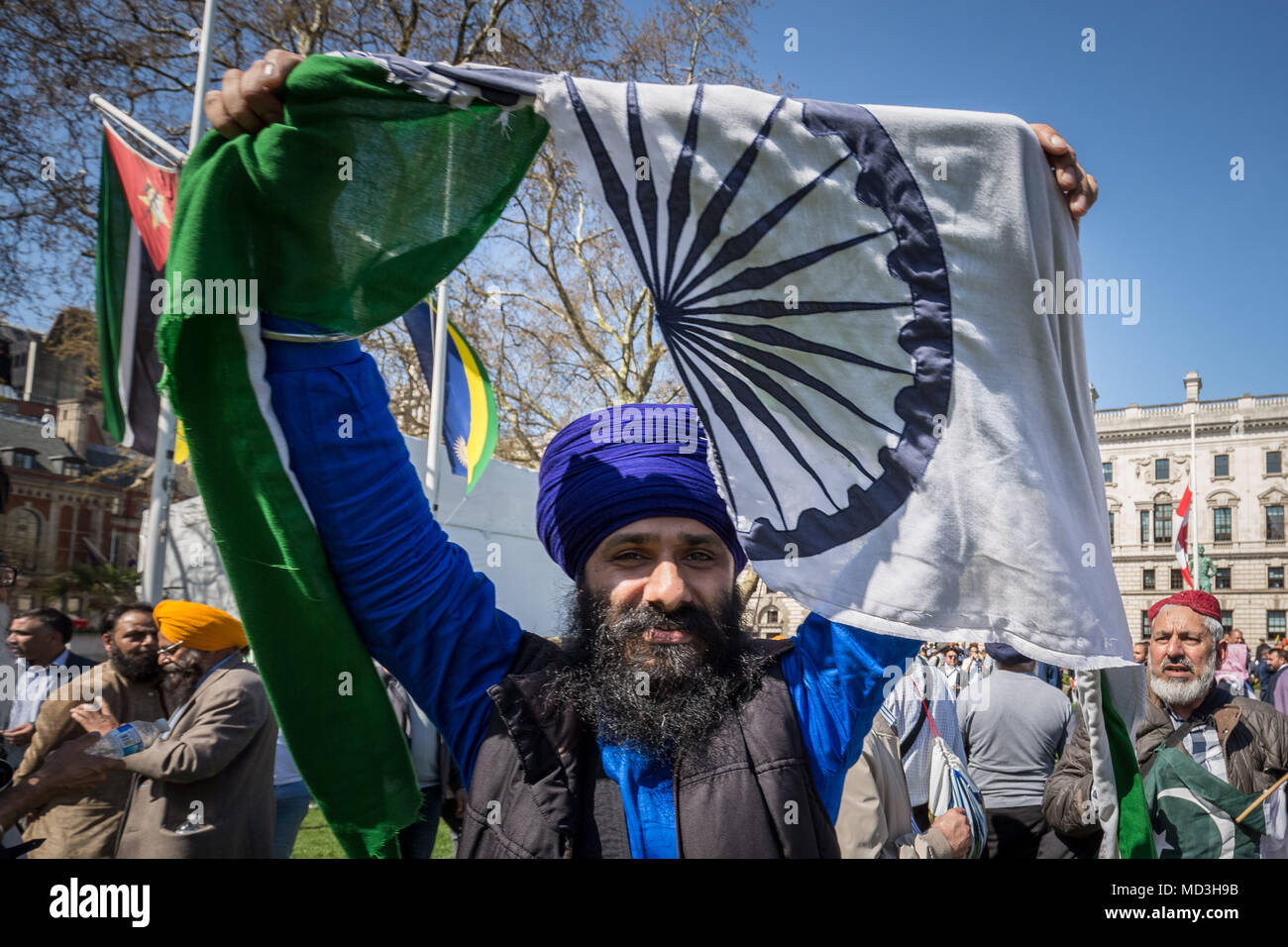 London, UK. 18th April, 2018. Anti-Modi Sikh protesters tear down the ...
