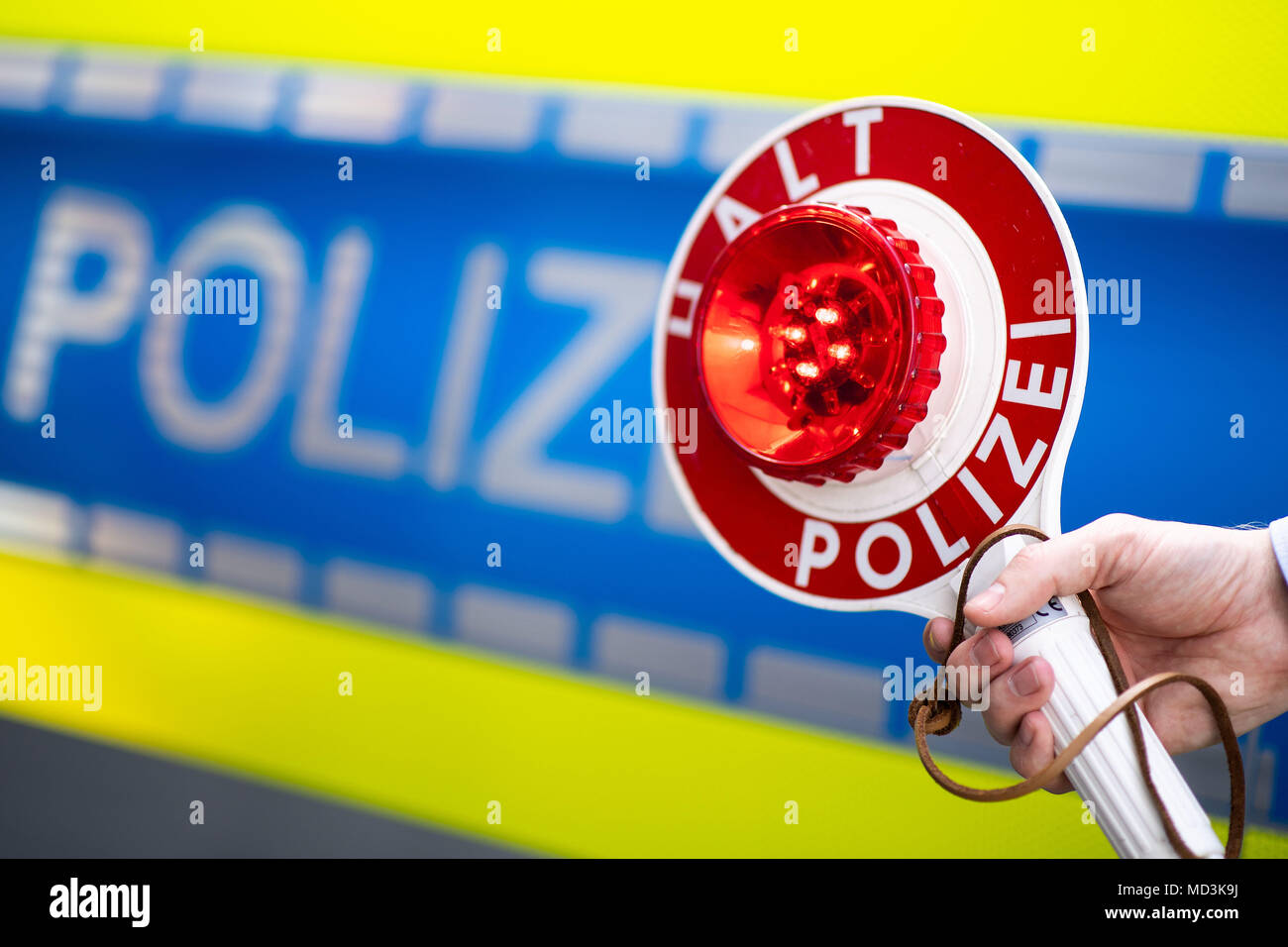18 April 2018, Germany, Moenchengladbach: A police officer holds up a ...