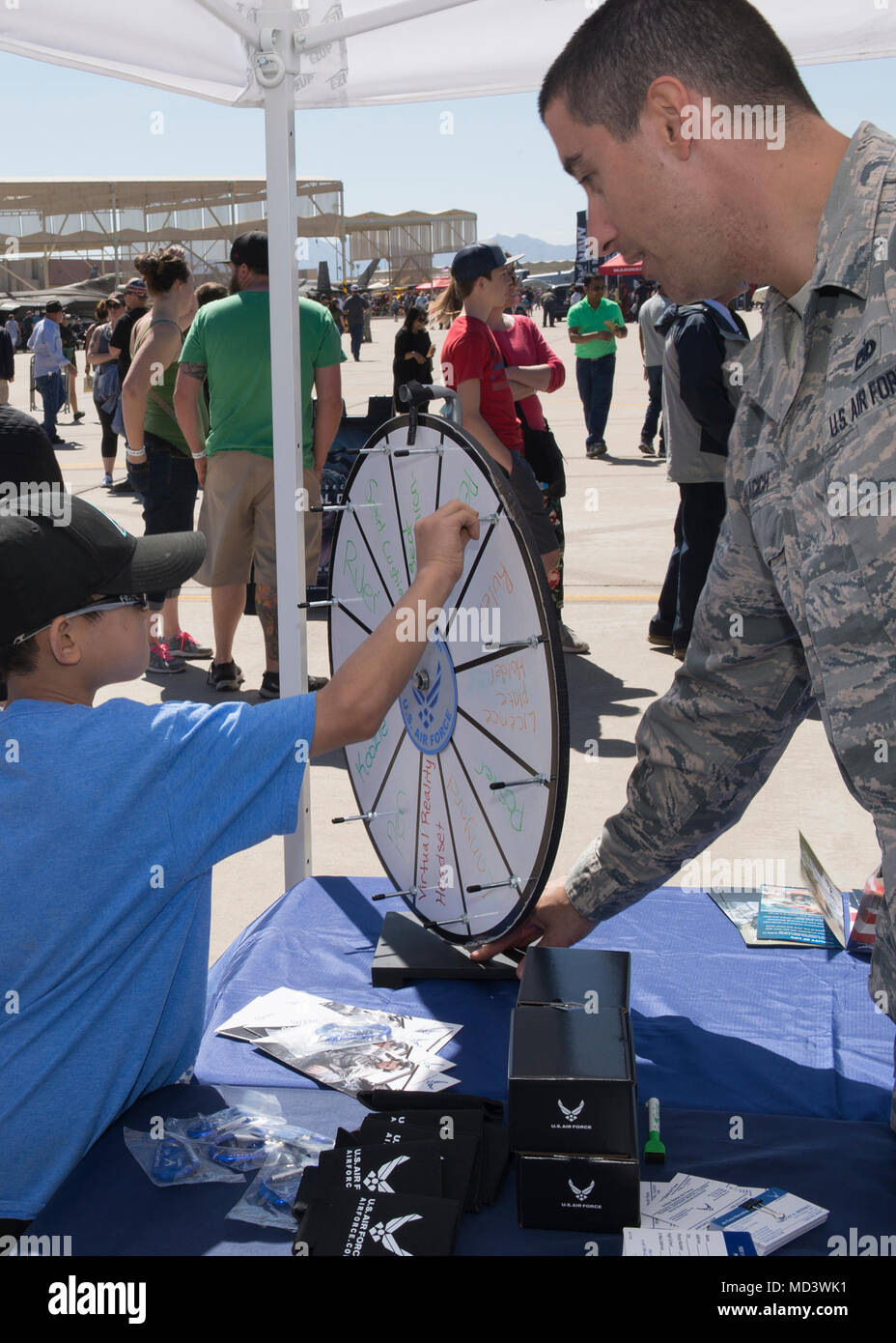 A child spins a prize wheel at the Air Force recruiters’ booth during ...