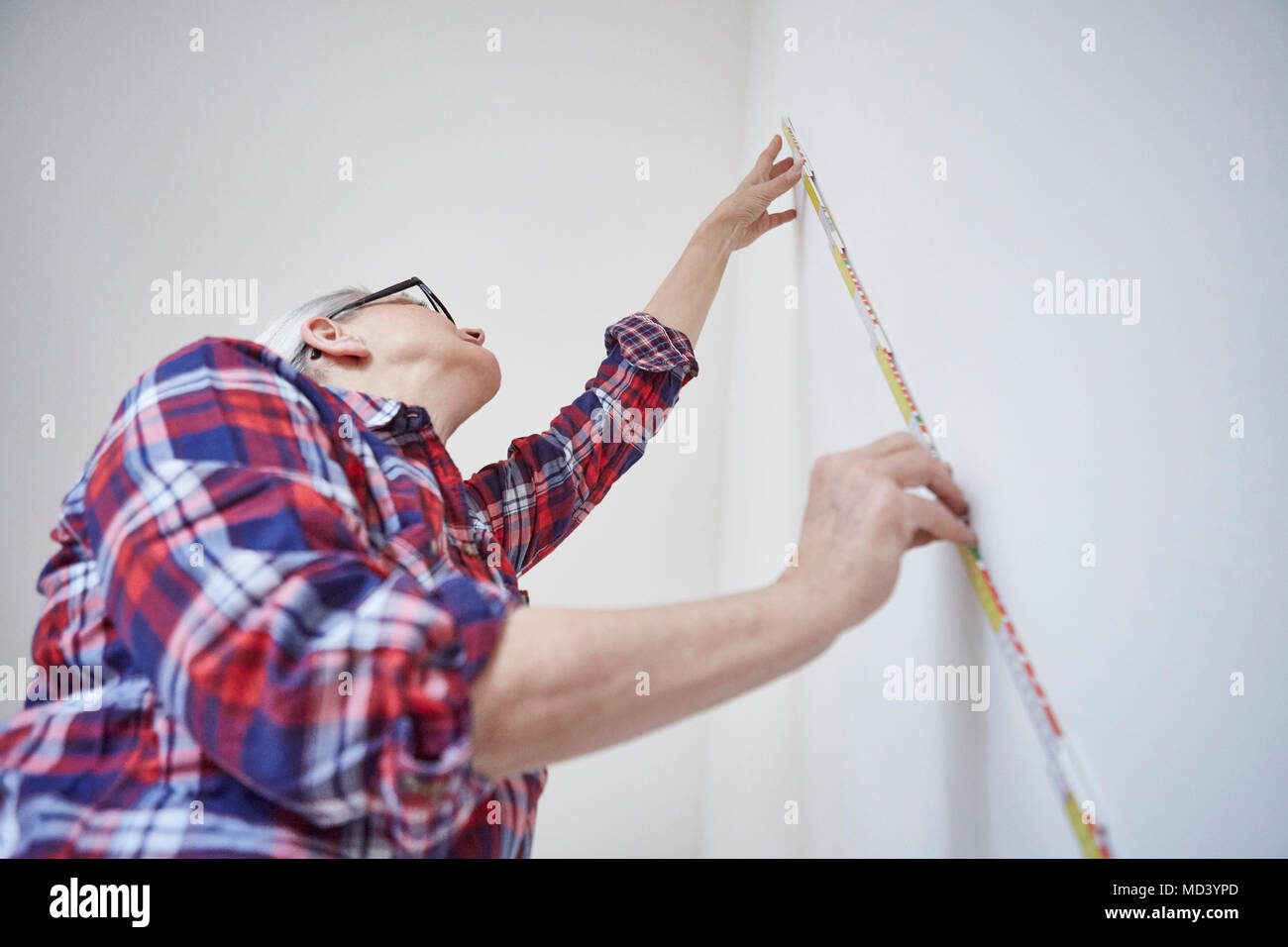 Woman measuring wall measuring tape hi-res stock photography and images ...