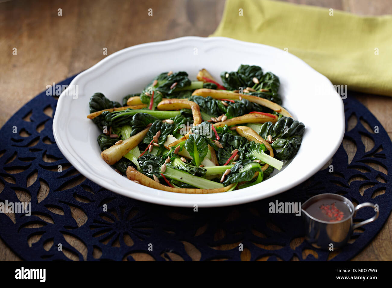 Chard and parsnip salad with pine nuts in bowl Stock Photo - Alamy