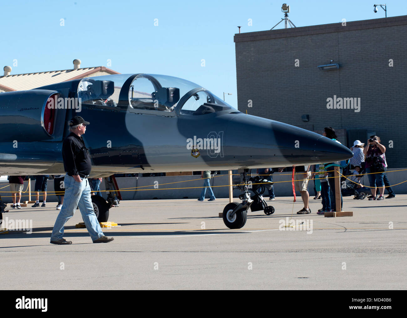An air show guest walks around an L-39C Albatros during Luke Days at ...