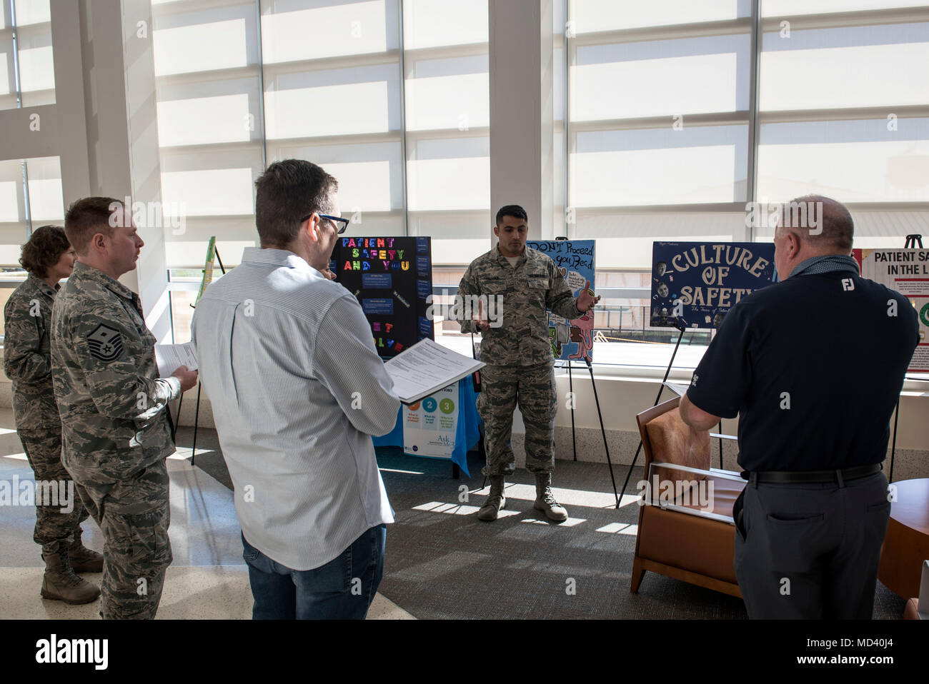 A U.S. Airman present his unit’s safety poster to a panel of judges at ...