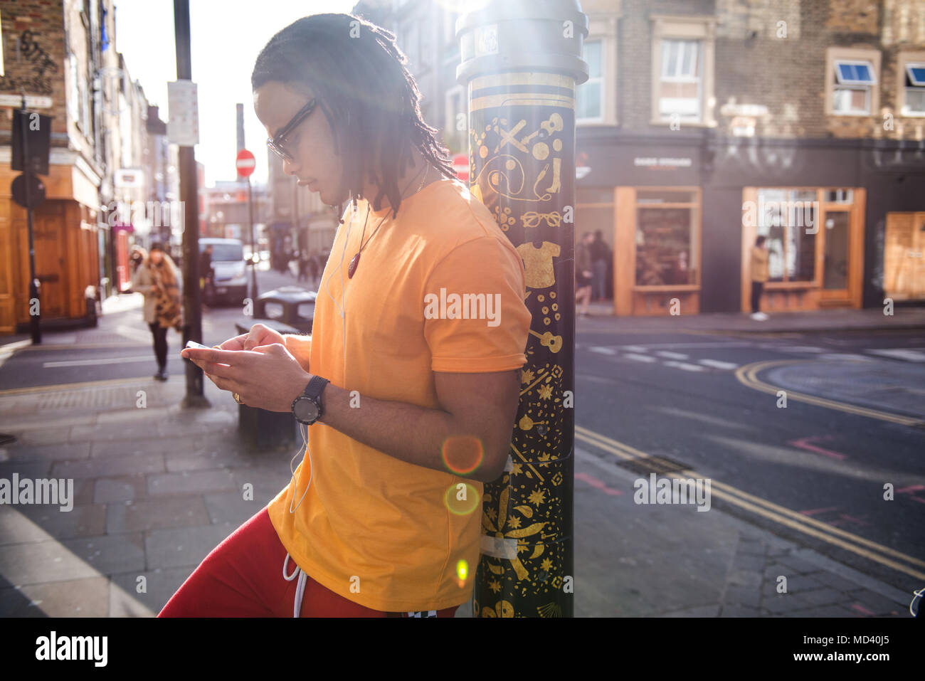 Male leaning against lamppost hi-res stock photography and images - Alamy