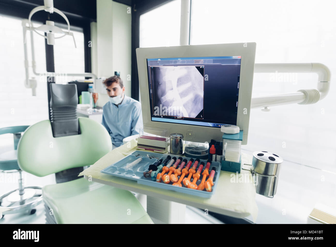Dental x-ray on computer screen, dentist in background Stock Photo - Alamy