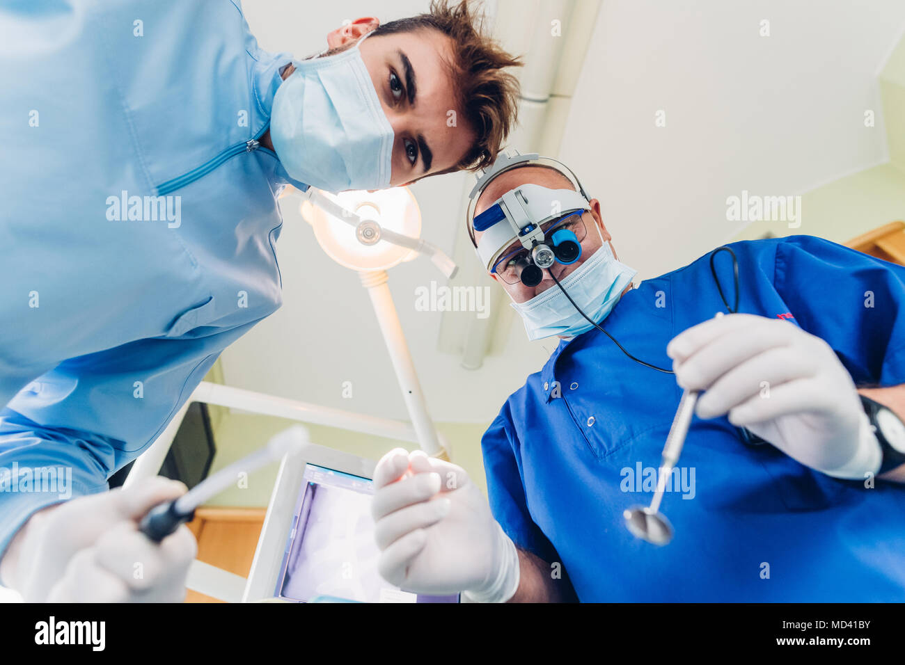 Dentist and dental nurse treating patient, personal perspective Stock ...