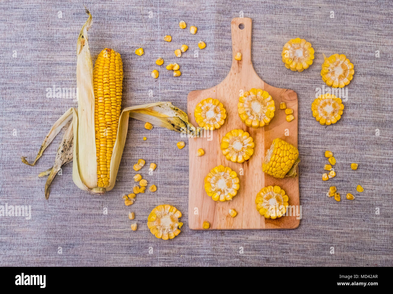 Sliced corn on the cob on chopping board, overhead view Stock Photo - Alamy