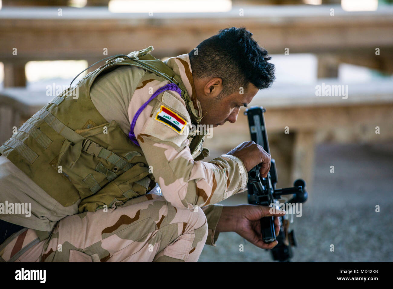 An Iraqi soldier, with the 74th Brigade, practices disassembly of an ...