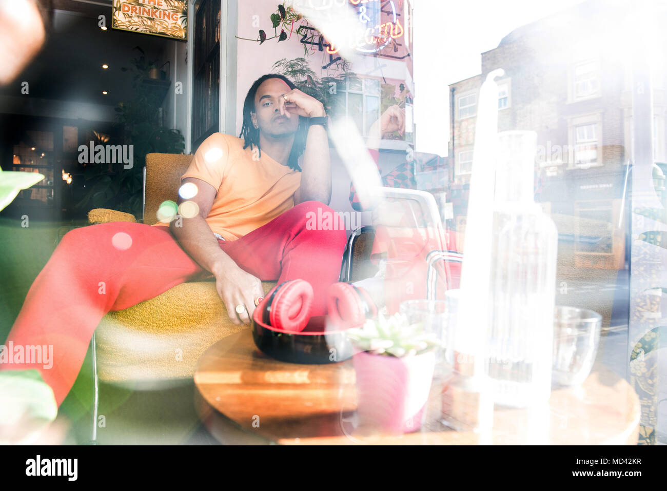 Young man relaxing in bar Stock Photo - Alamy