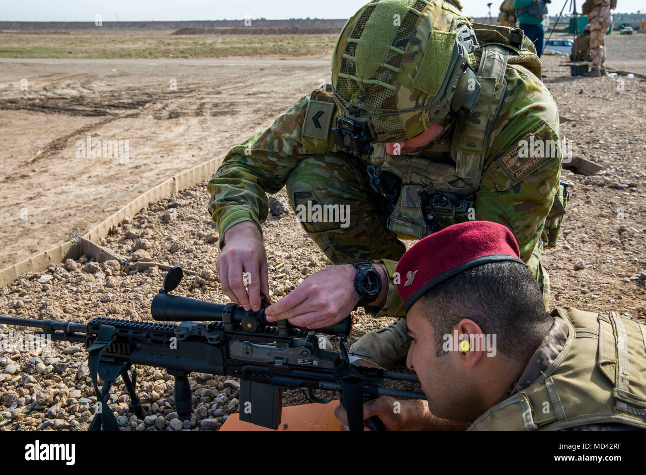 An Australian soldier, with Task Force Taji, adjusts the elevation knob ...