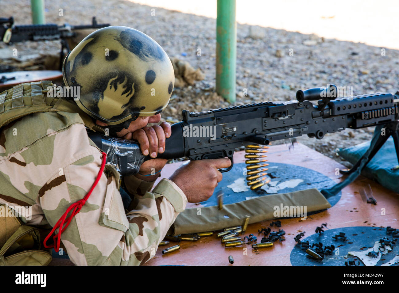 An Iraqi soldier assigned to 74th Brigade fires an M240B machine gun ...