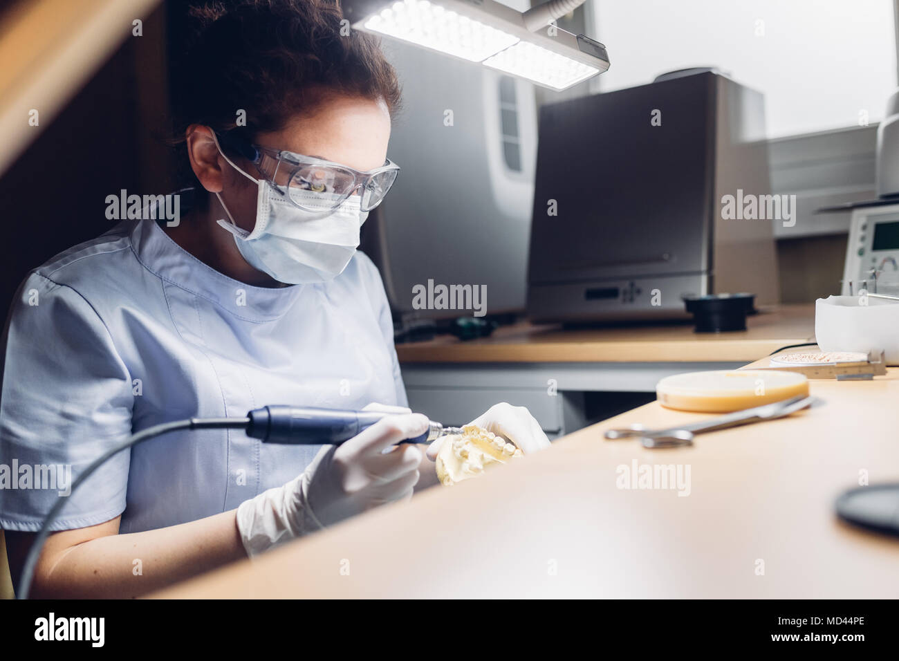 Dentist making denture in laboratory Stock Photo - Alamy