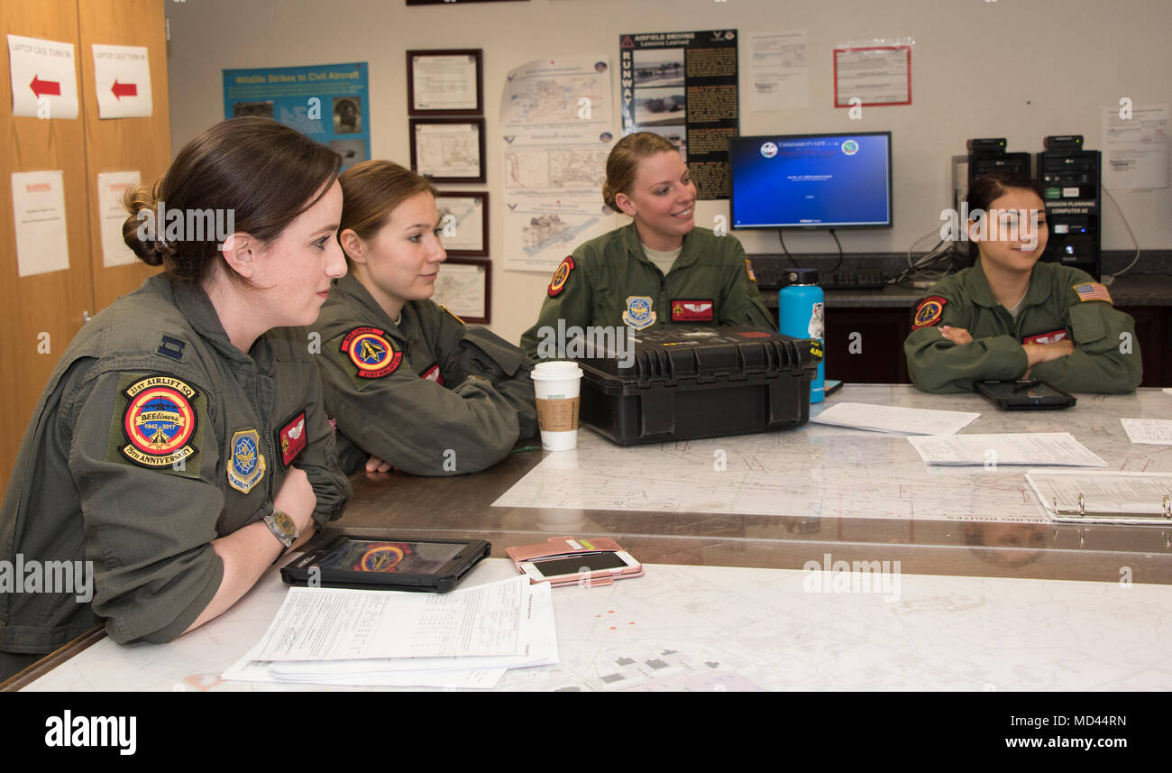 Aircrew members assigned to the 21st Airlift Squadron, listen to a ...