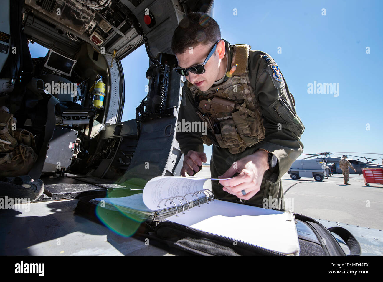 A pilot from the 41st Rescue Squadron (RQS) reads a flight plan, March ...