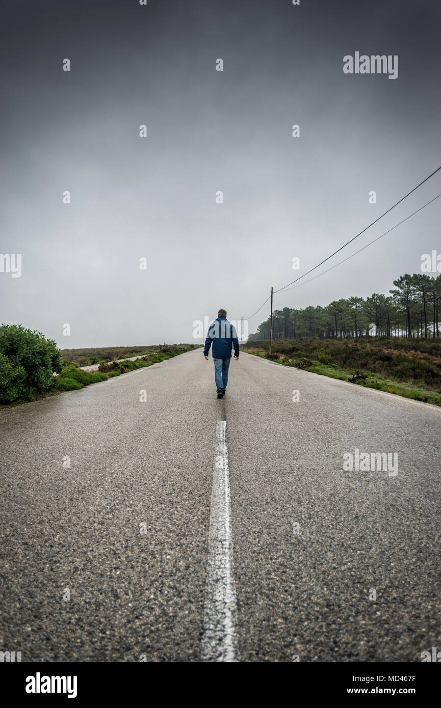 Man walking lonely road hi-res stock photography and images - Alamy