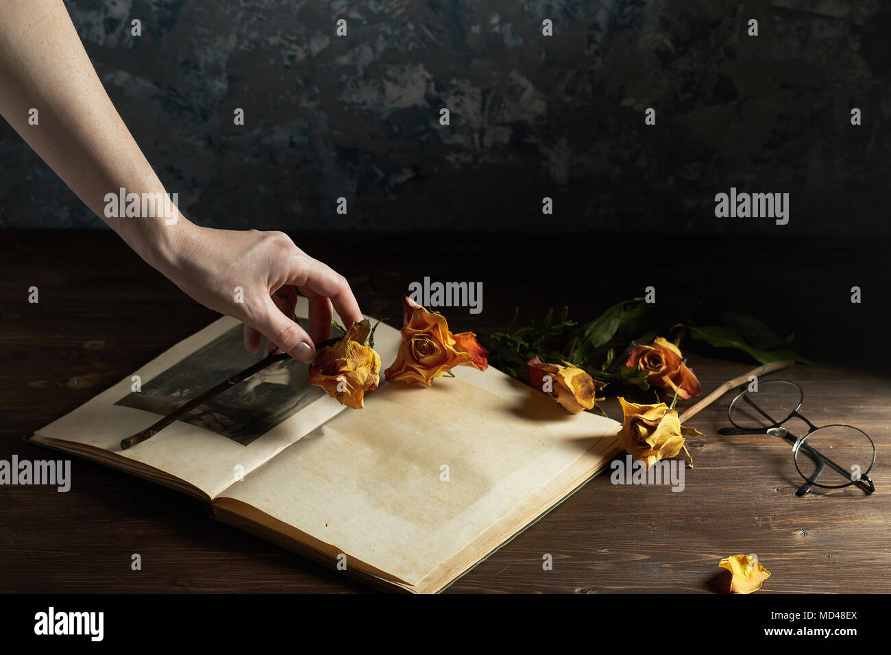 Still life book on the table with flowers and glasses. place for text ...