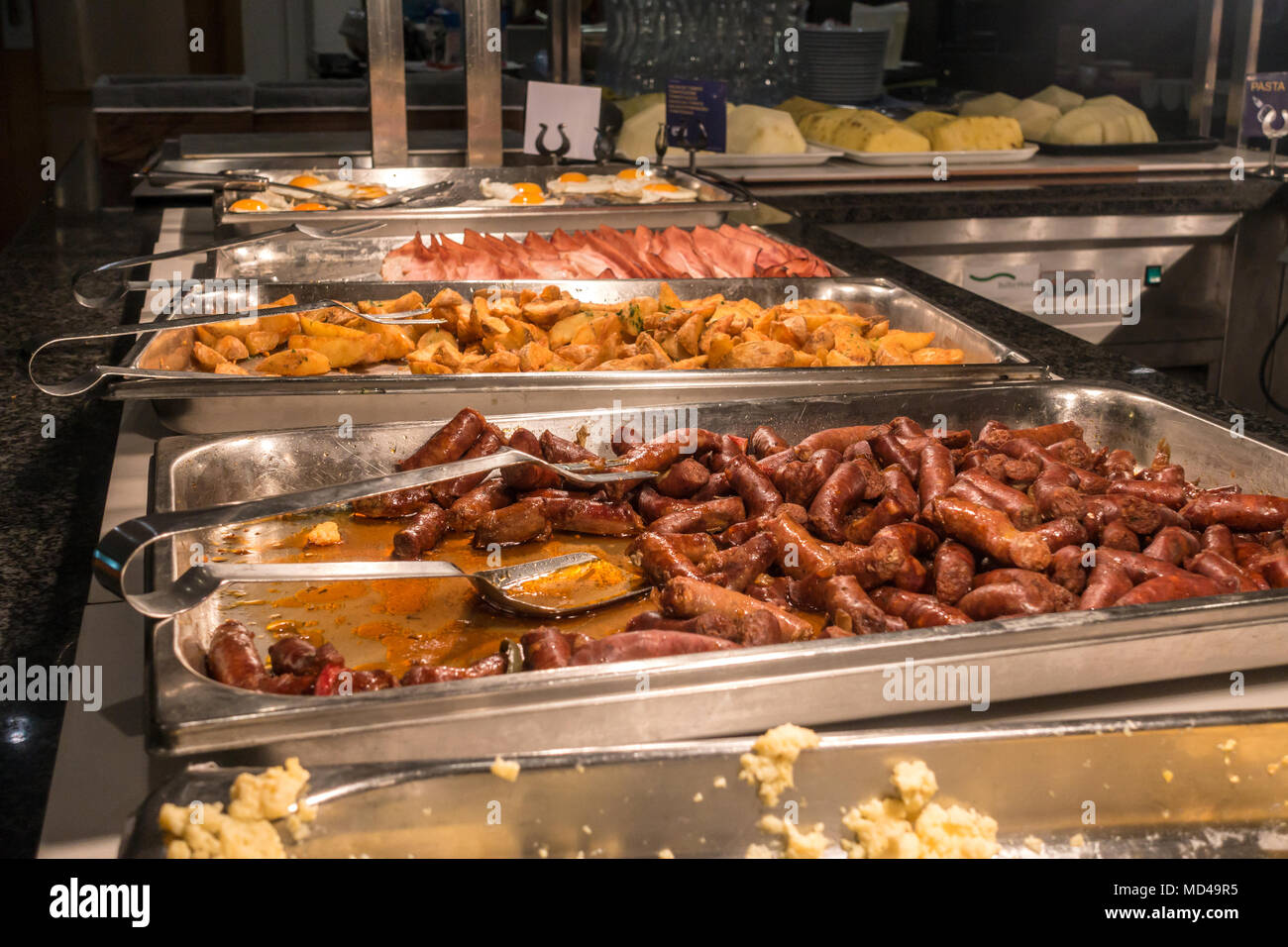 A selection of cooked breakfast items available at a self service ...
