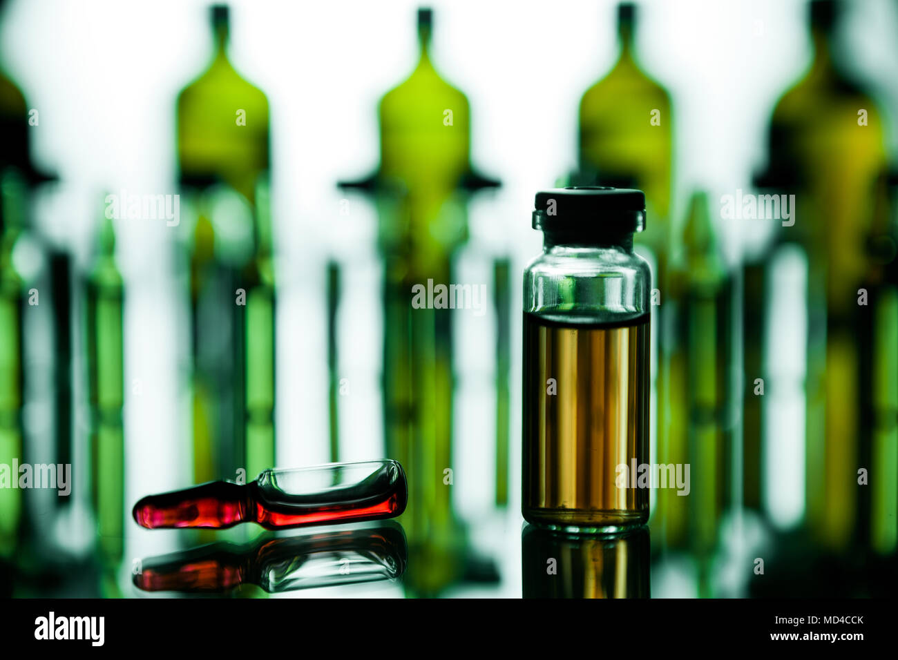 Production of medicines. lot of ampoules on light background. Group of ...
