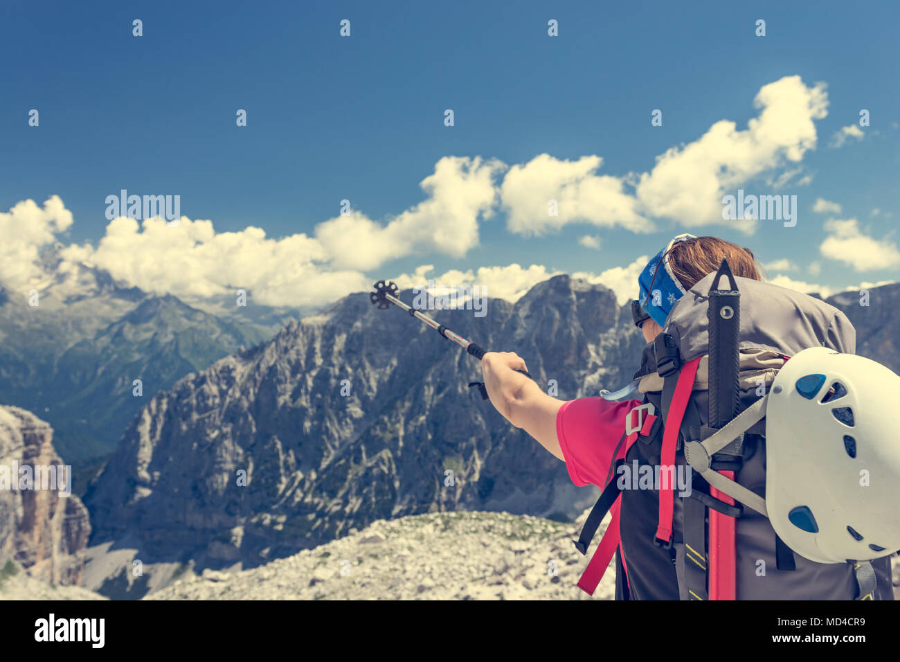 Female climber pointing towards next challenge Stock Photo - Alamy