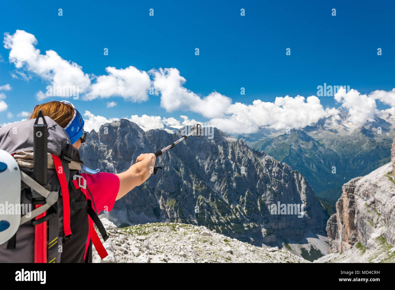 Female climber pointing towards next challenge Stock Photo - Alamy