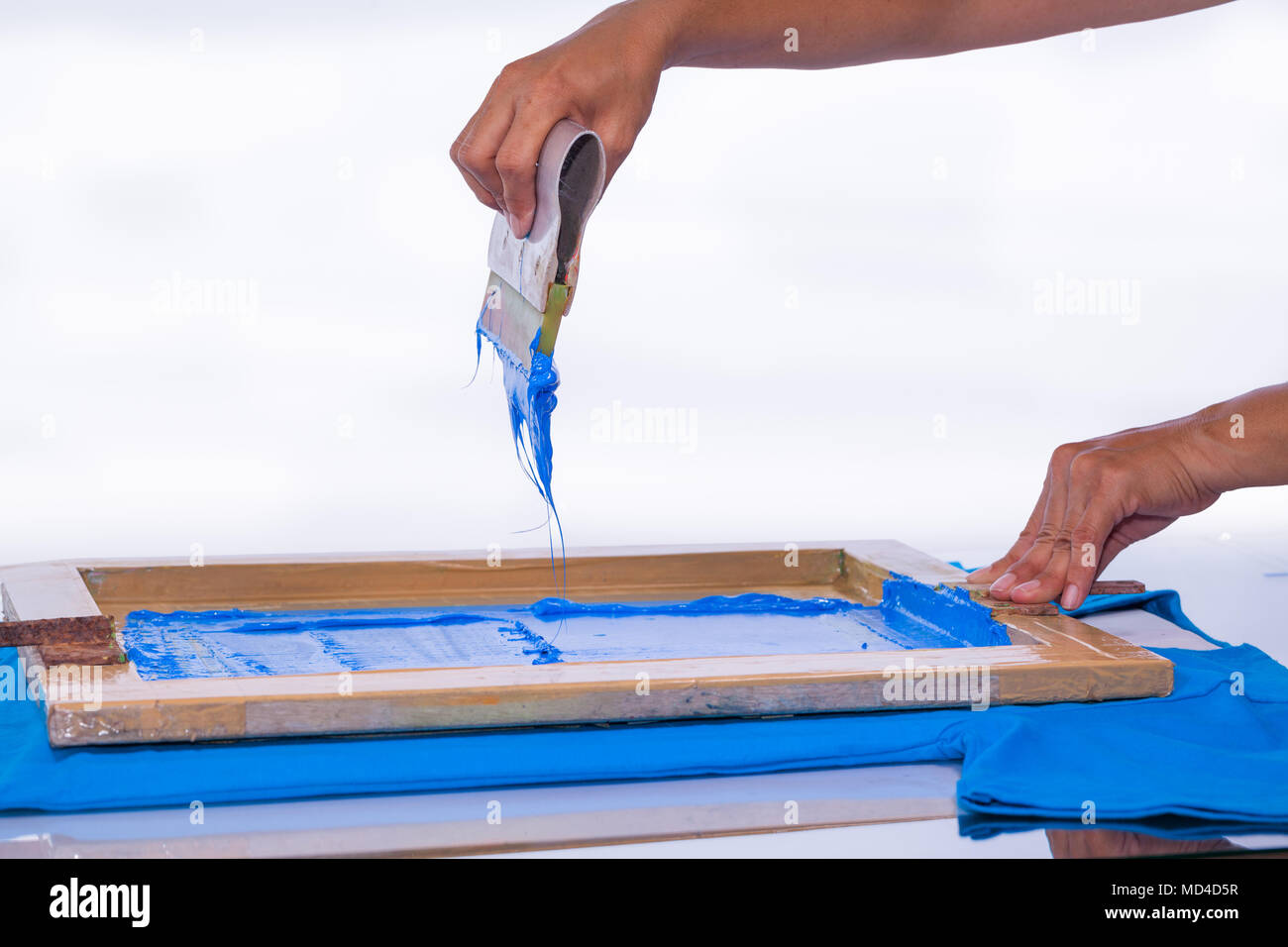 hand made screen printing with blue color print on blue tee shirt Stock ...