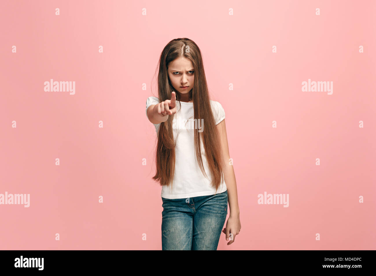 The teen girl pointing to you, half length closeup portrait on pink ...