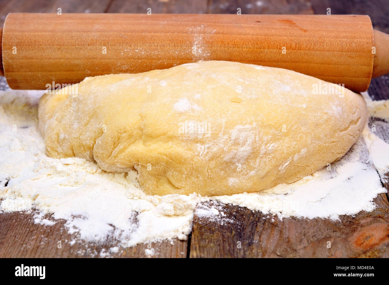 rolling pin and dough on a wooden table Stock Photo - Alamy
