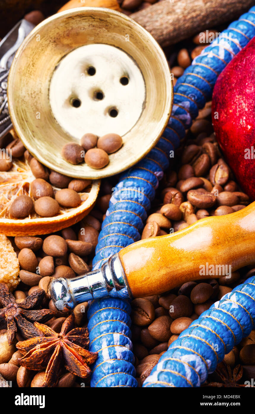 Smoke hookah with with coffee beans and pomegranate.Shisha concept ...