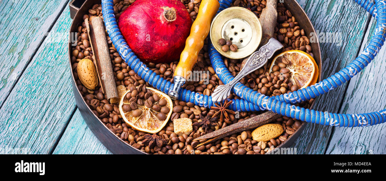 Smoke hookah with with coffee beans and pomegranate.Shisha concept ...