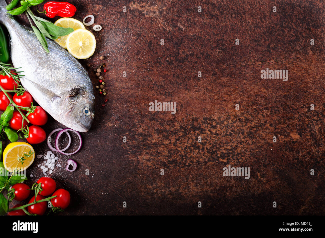 Uncooked fish on dark vintage background. Free space for your text ...