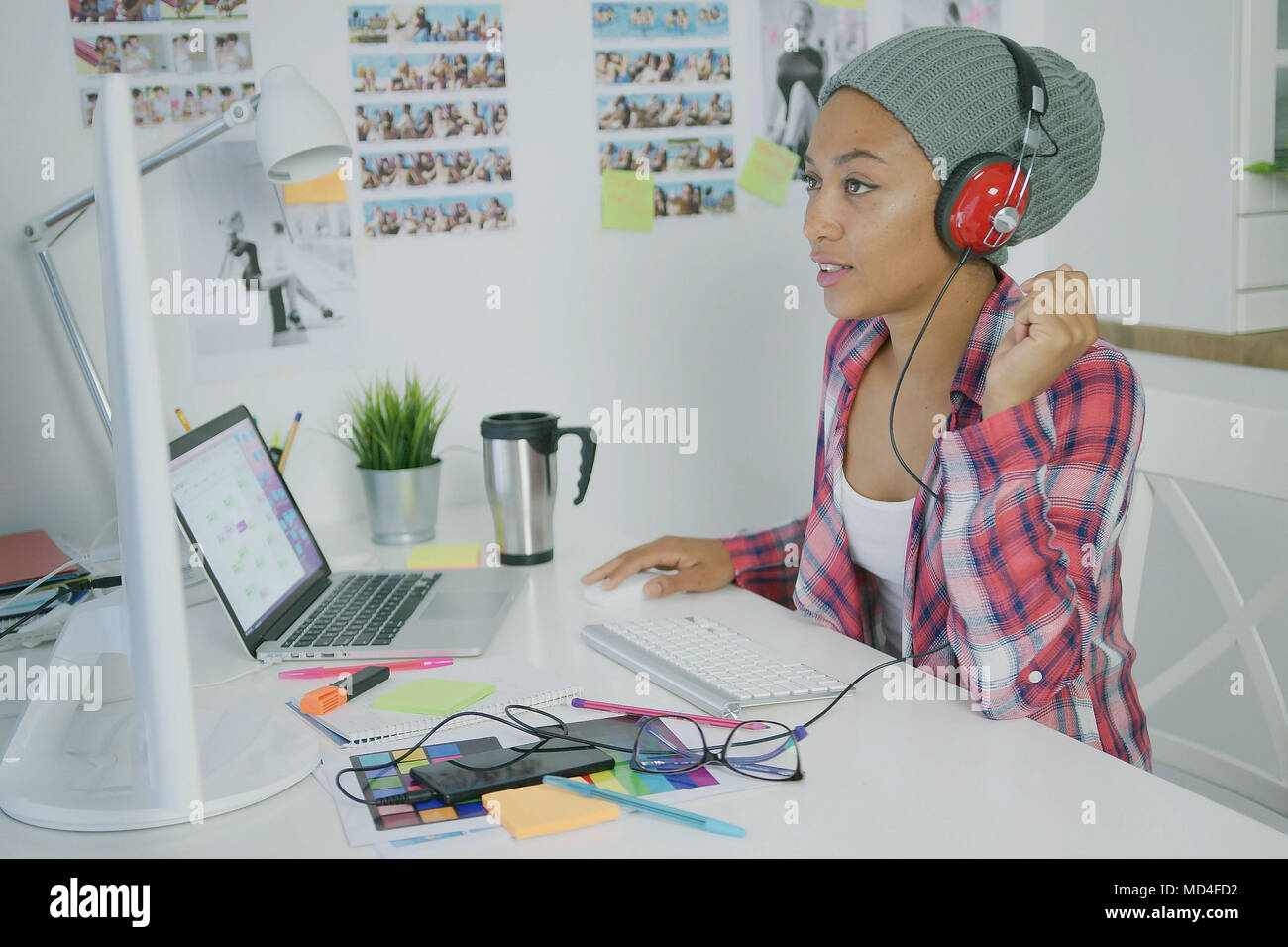 Trendy worker in headphones working Stock Photo - Alamy