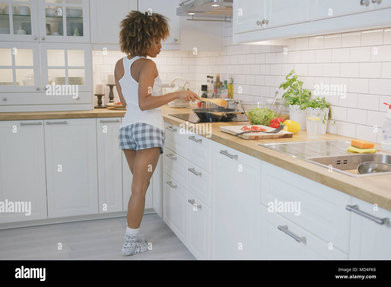 Adorable model dancing happily while cooking Stock Photo - Alamy