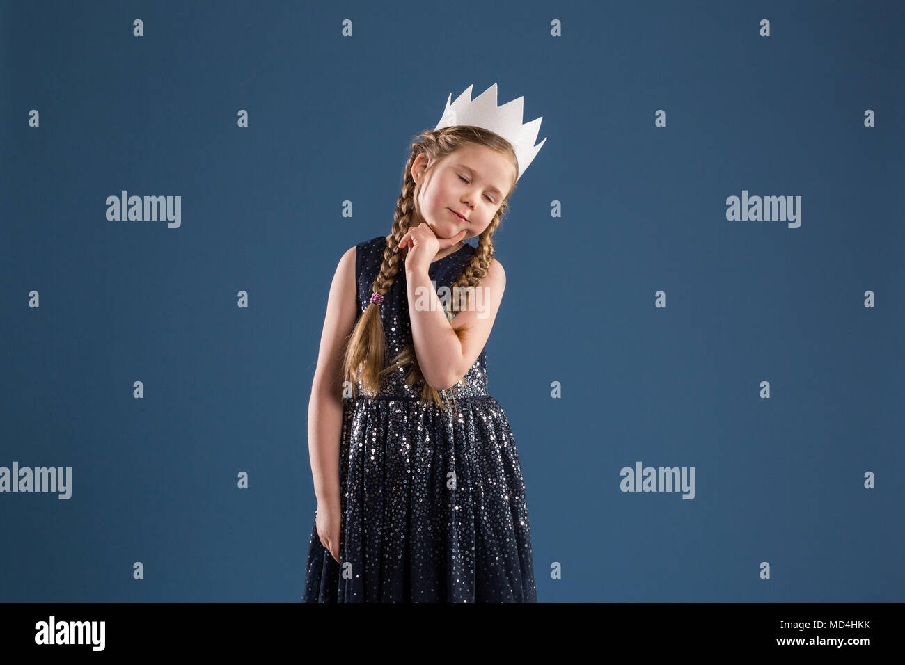 Portrait of dreamy girl in princess costume standing with closed eyes ...