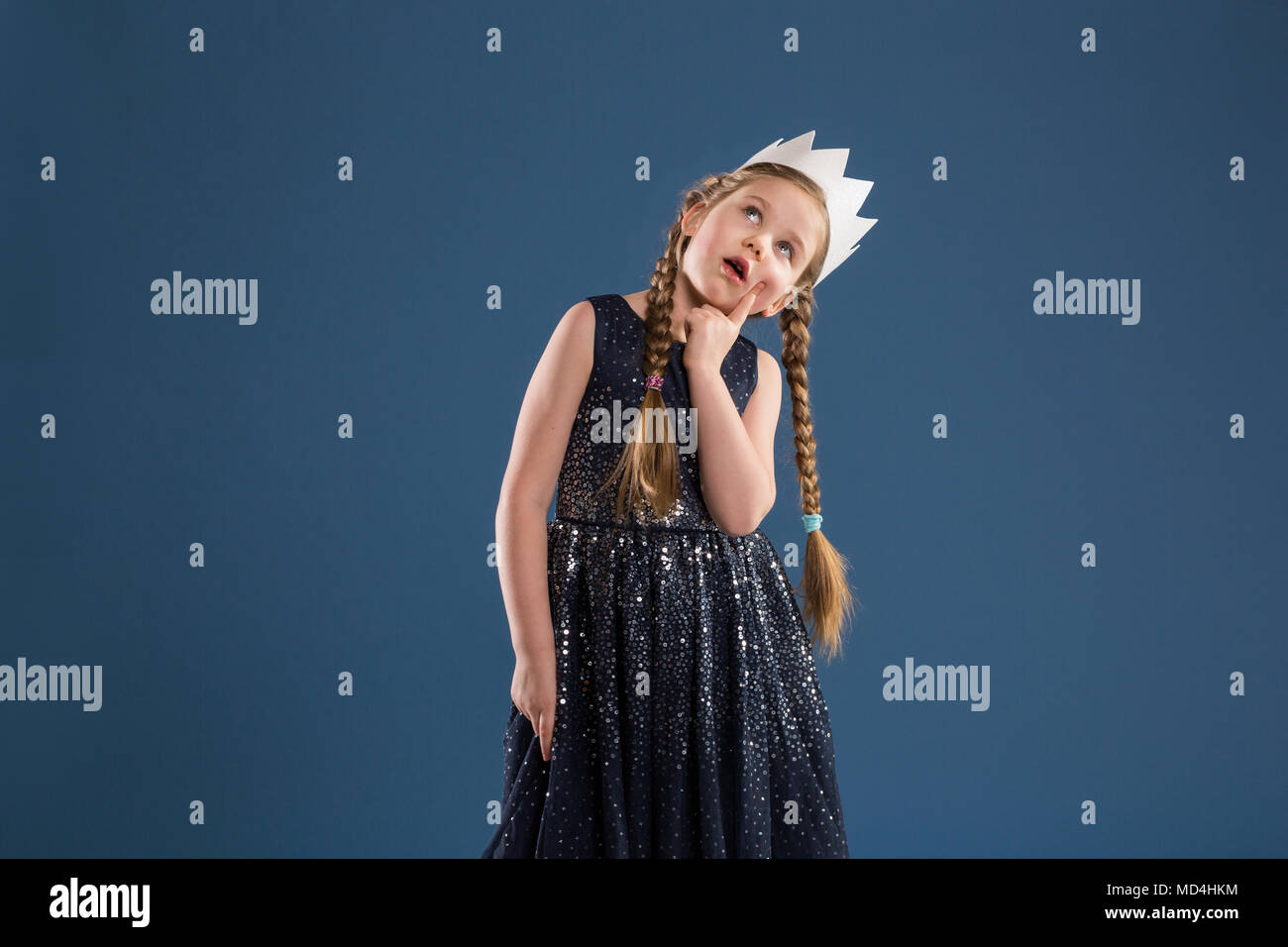 Portrait of girl in princess costume looking away thinking Stock Photo ...
