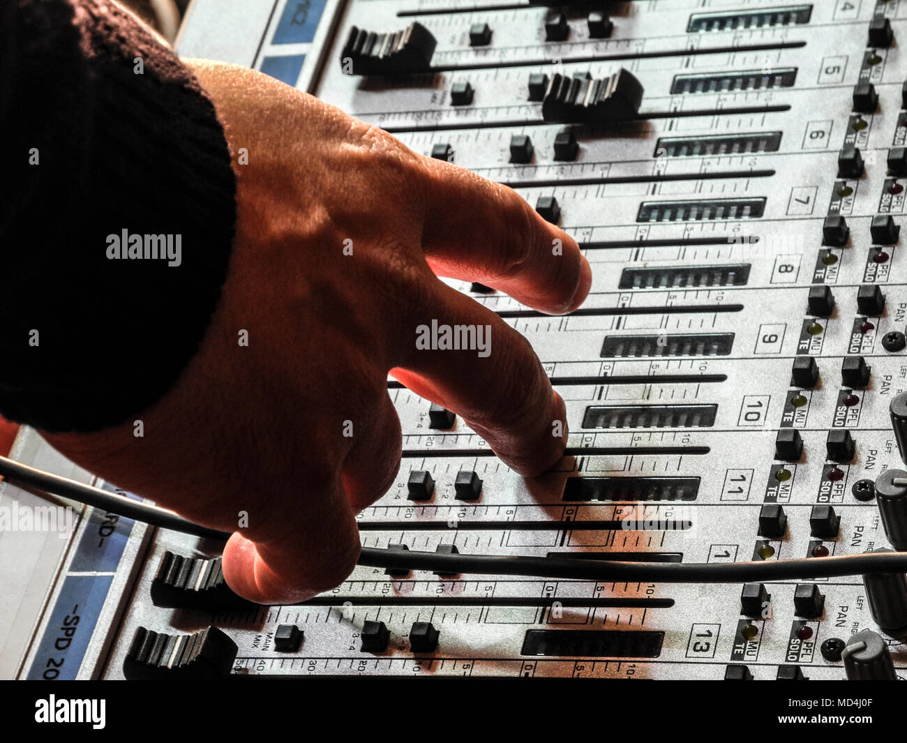 hand adjusting sound mixer settings Stock Photo - Alamy
