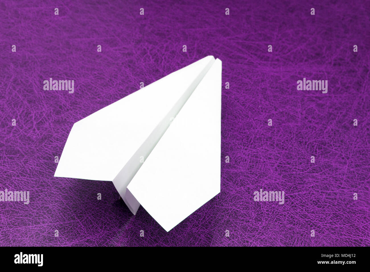 Paper airplane on a blue paper background Stock Photo - Alamy
