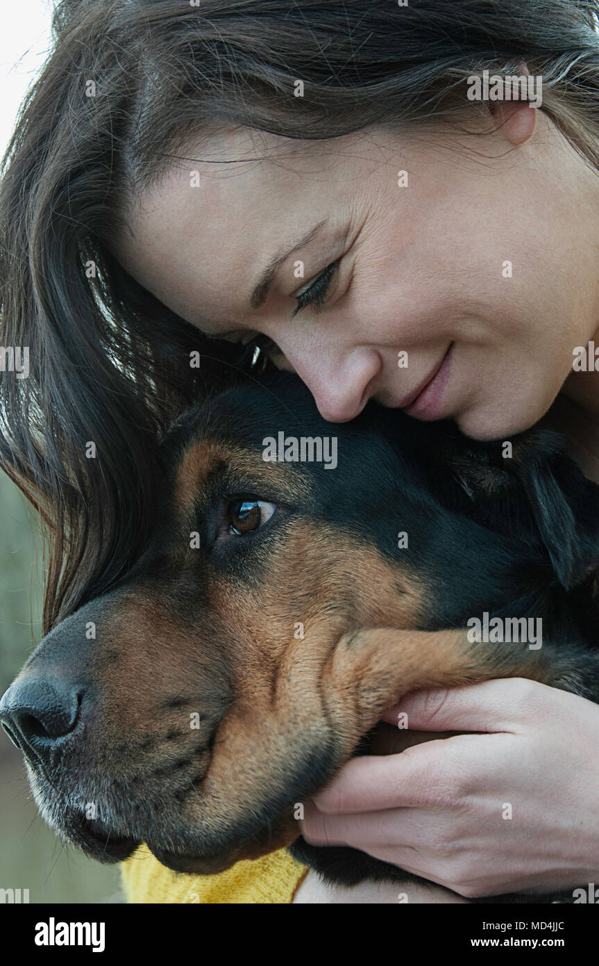 A close up of a woman embracing her dog Stock Photo - Alamy