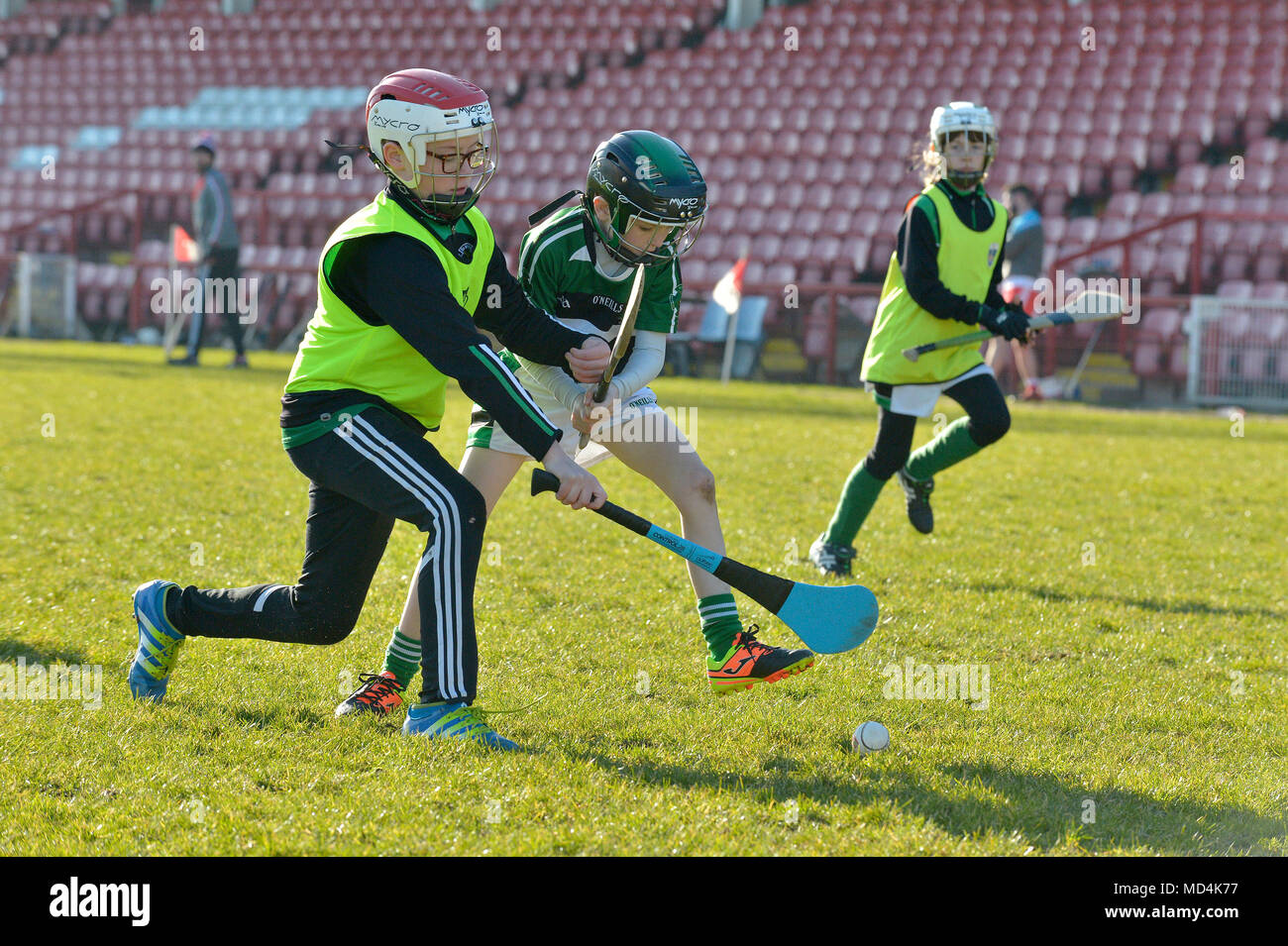 Primary school children playing GAA hurling at Celtic Park, Derry Stock ...
