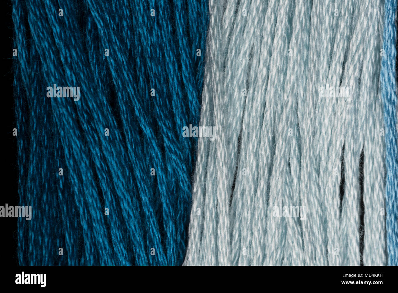 deep blue, blue, light blue and white cotton threads macro close up ...